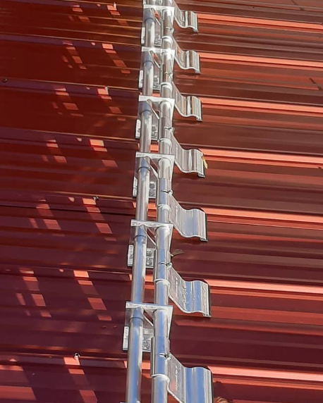 Why Do Exposed-Fastened Metal Roofs Need Continuous Snow Bars?